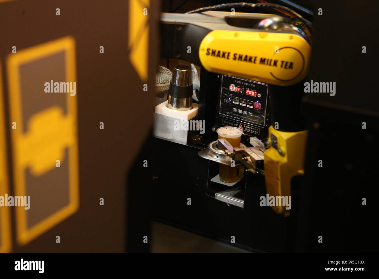 A robot arm makes milk tea at an automated store in Shanghai, China, 17 ...