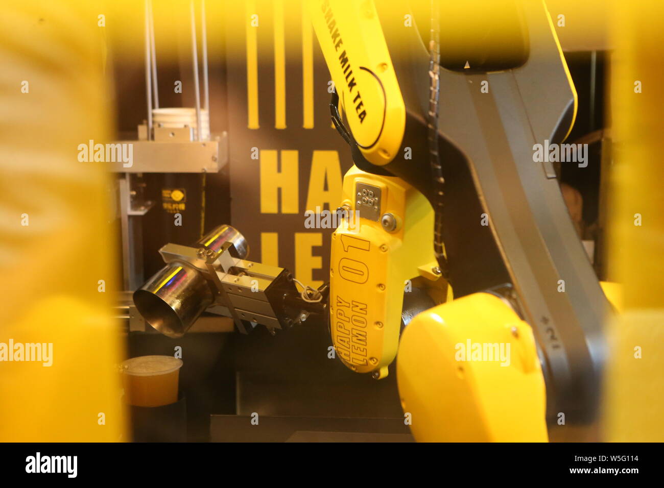 A robot arm makes milk tea at an automated store in Shanghai, China, 17 ...