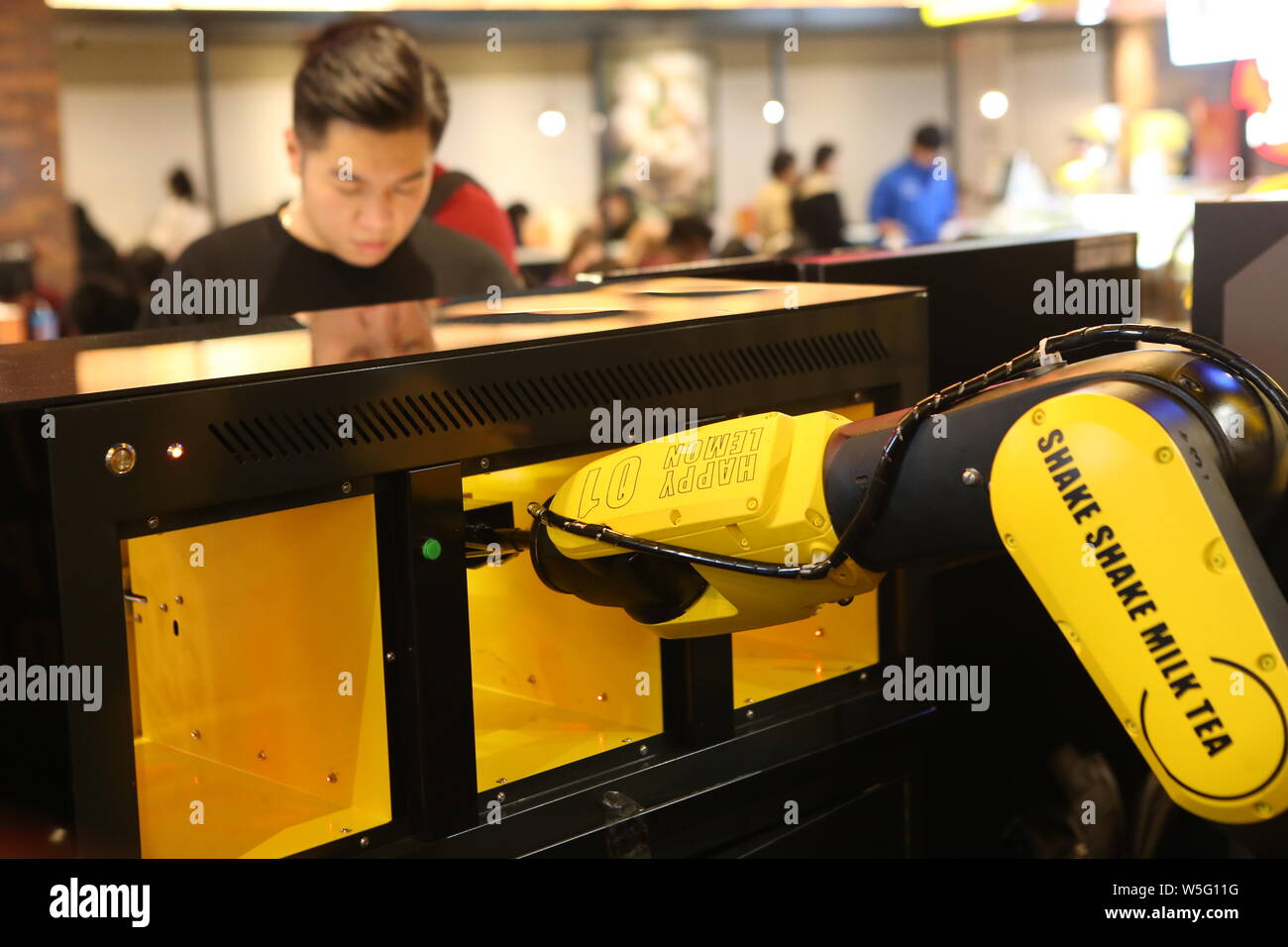 A robot arm makes milk tea at an automated store in Shanghai, China, 17 ...