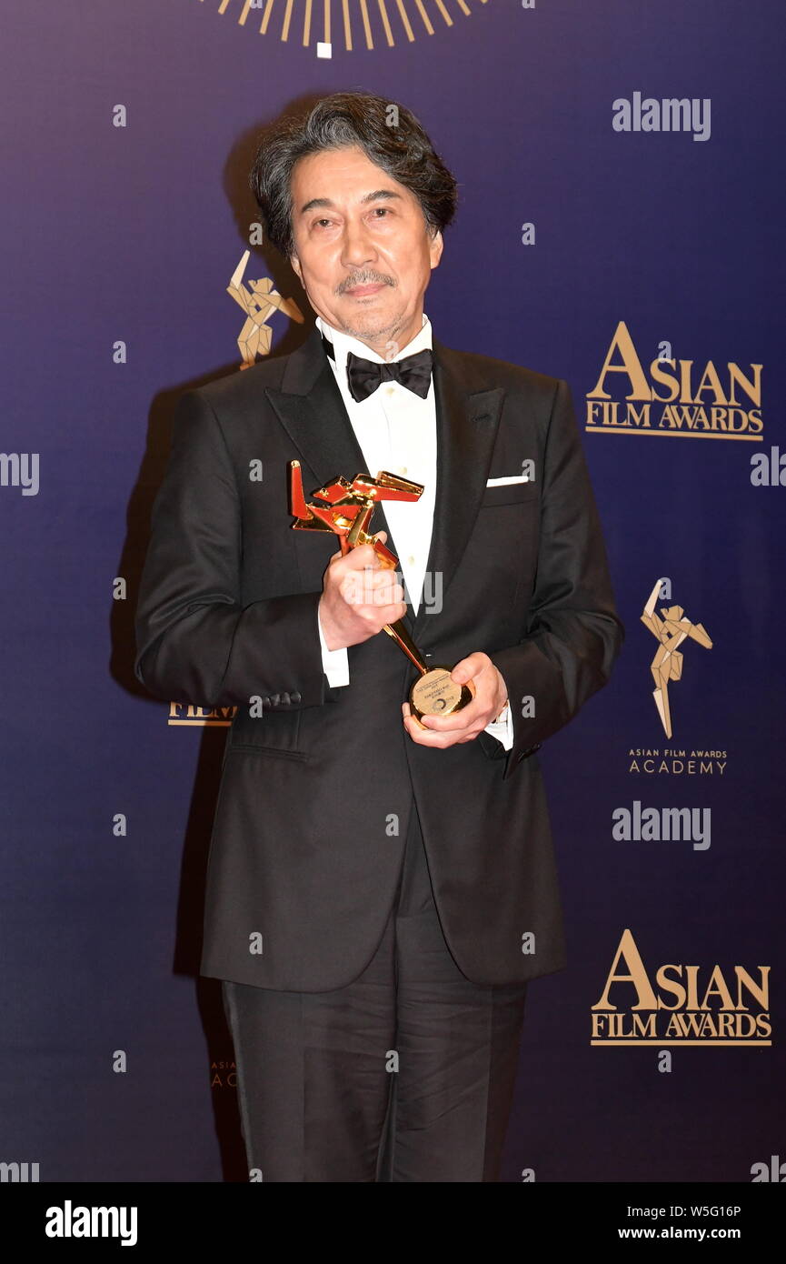 Japanese actor Koji Yakusho poses with his trophy after winning "Best ...