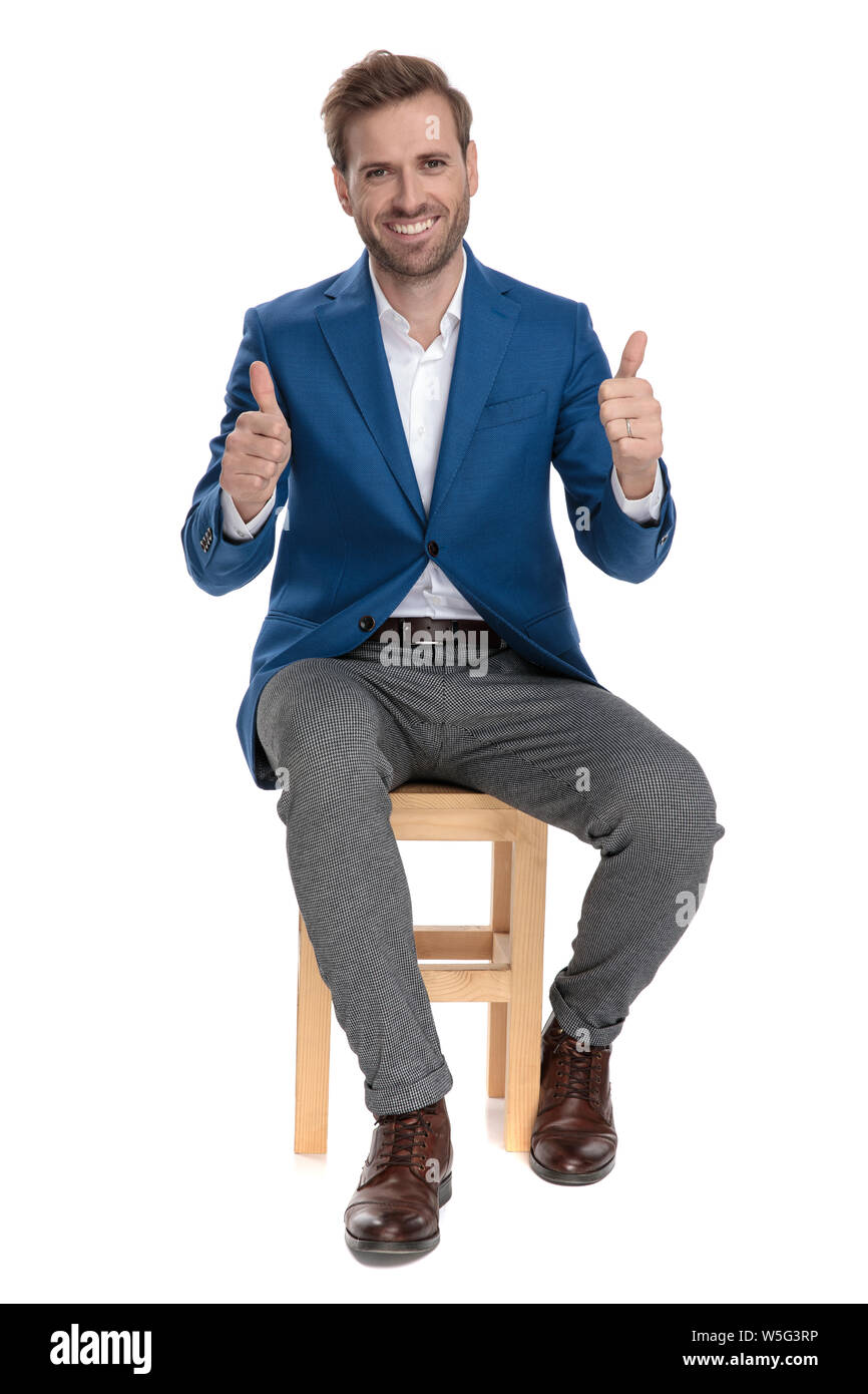 Successful casual man giving a double thumbs up and laughing while ...