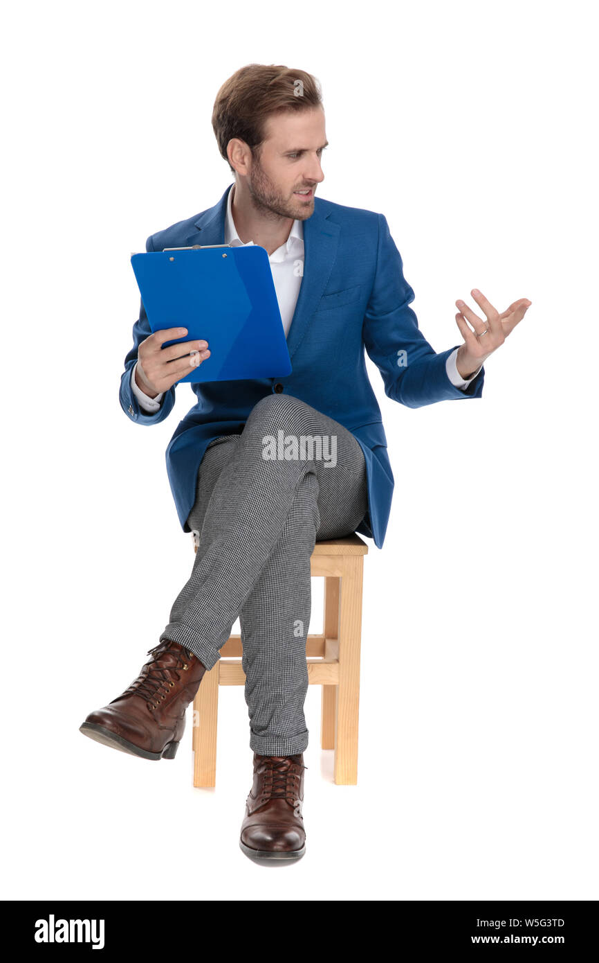 Angry businessman explaining and gesturing while frowning to the side ...