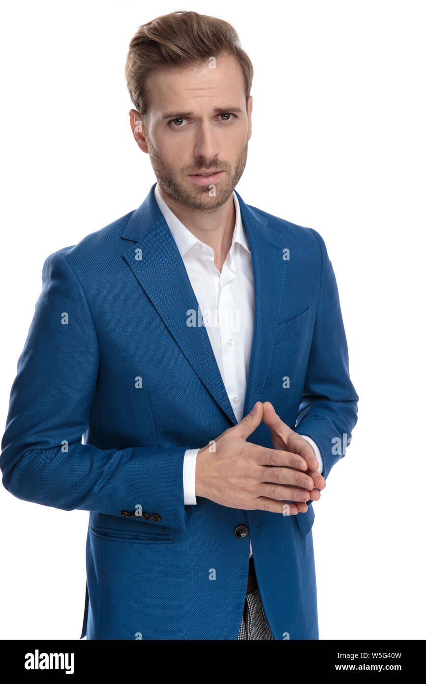 Serious looking casual man explaining something important while wearing ...