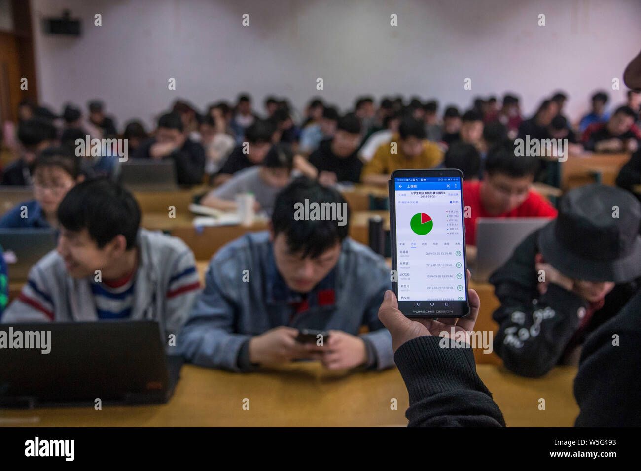 A teacher uses the App which helps tracking student attendance on his ...