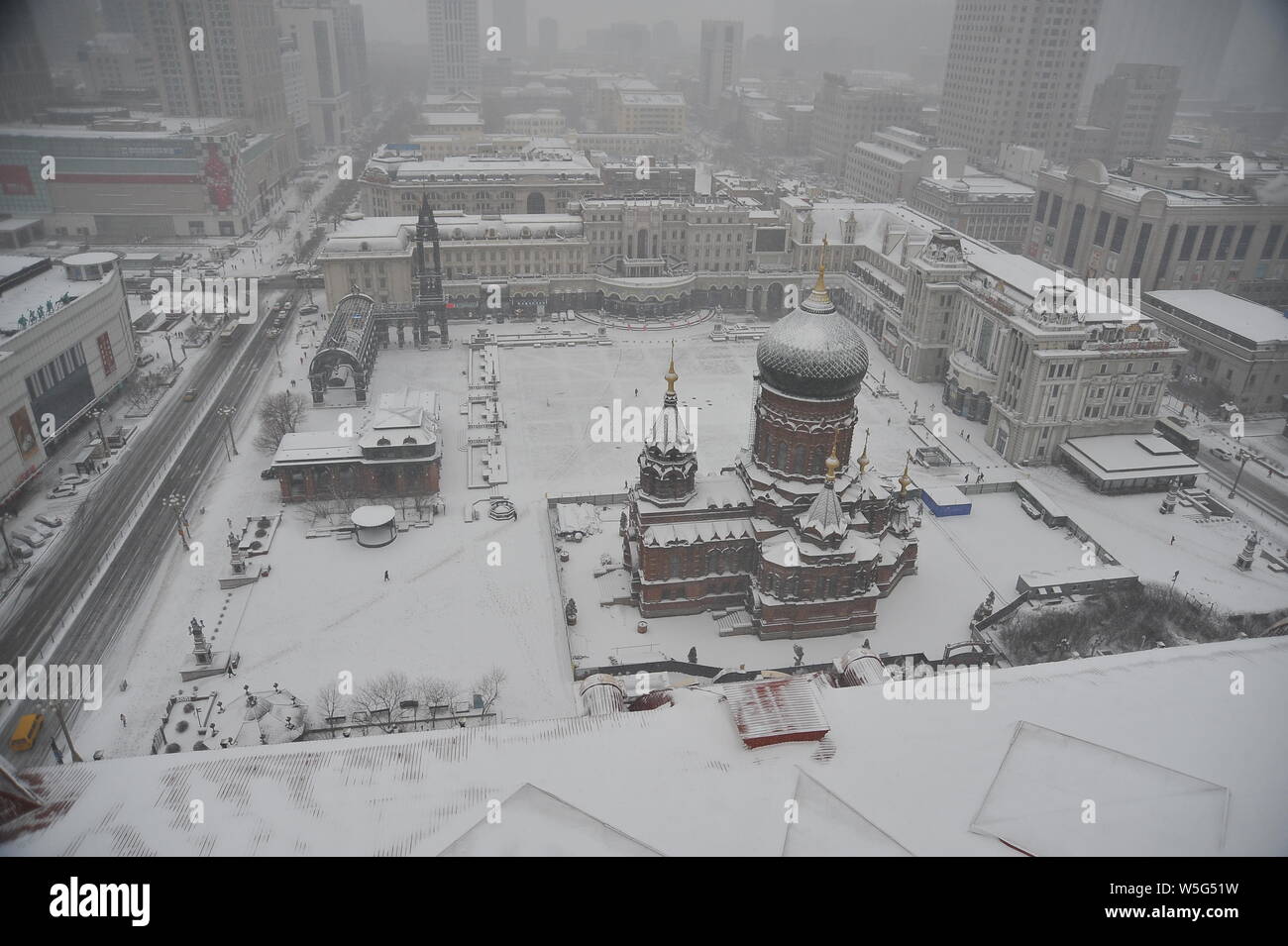 High-rising buildings are covered with snow during a snowfall on the ...