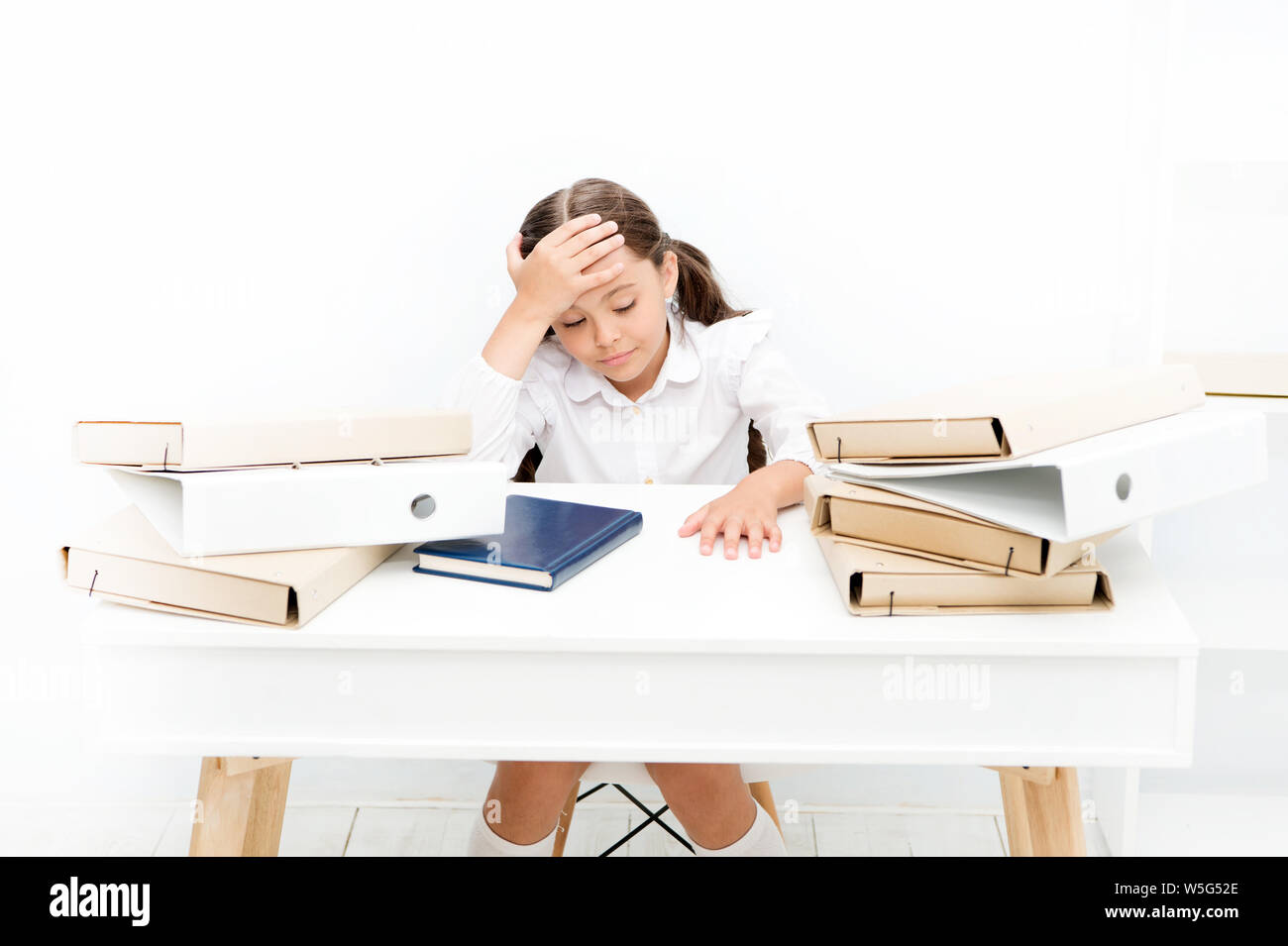 exhausted girl with workbook and folders. Education. boring lesson ...