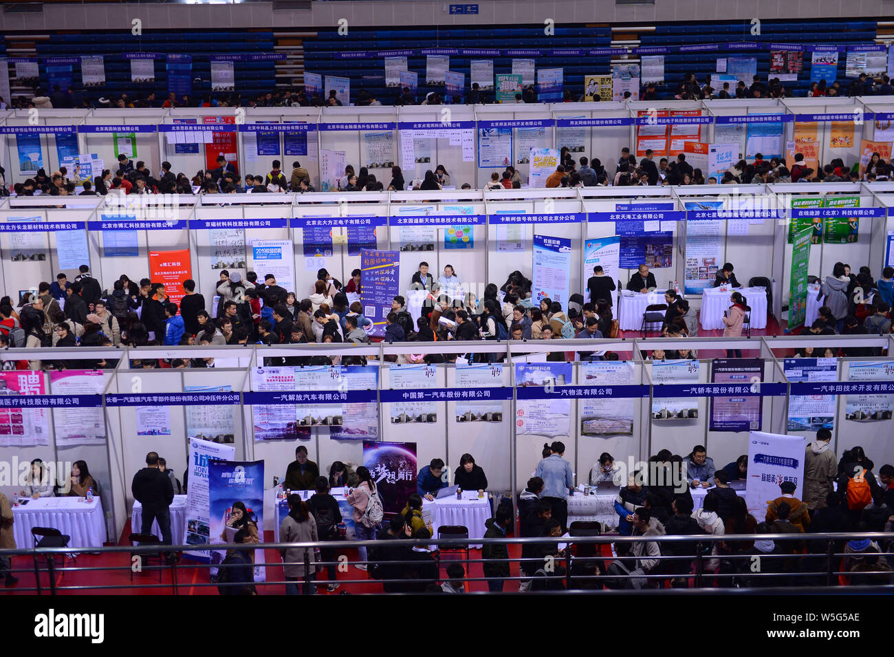 Chinese job seekers look for employment at a job fair in Shenyang city ...
