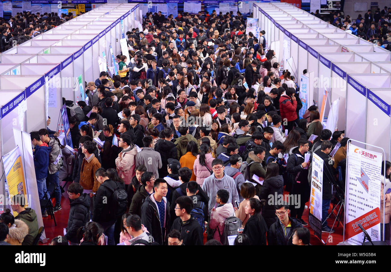 Chinese job seekers look for employment at a job fair in Shenyang city ...