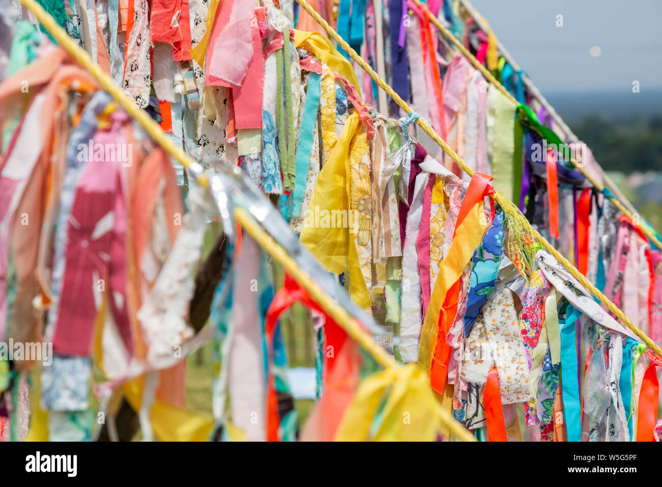 A tent adorned with colourful rags at a festival, UK Stock Photo - Alamy