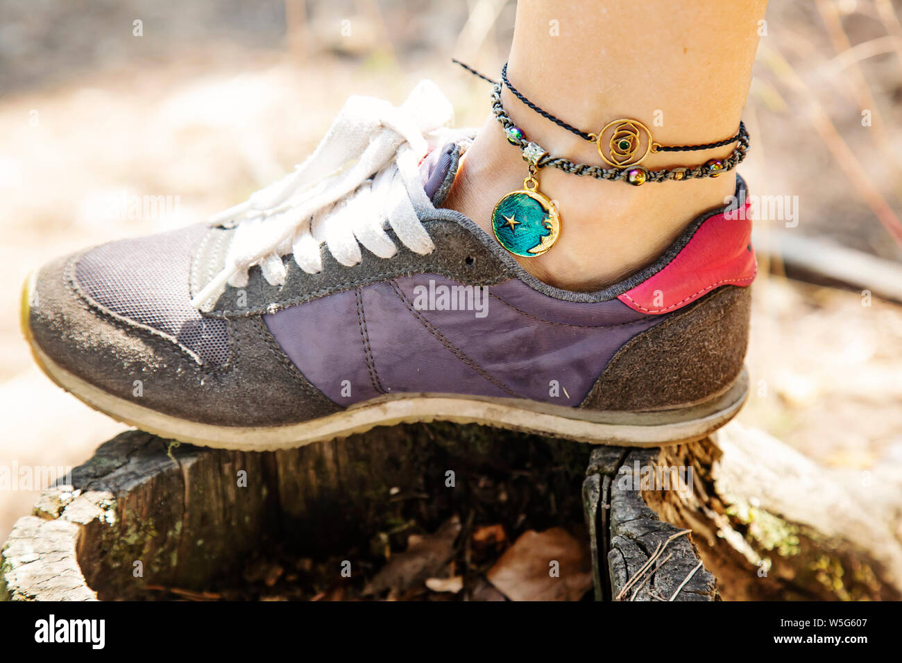 Female feet on stump in forest Stock Photo - Alamy