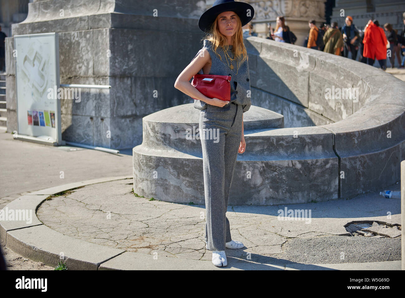 A trendy woman poses for street snaps during the Paris Fashion Week ...