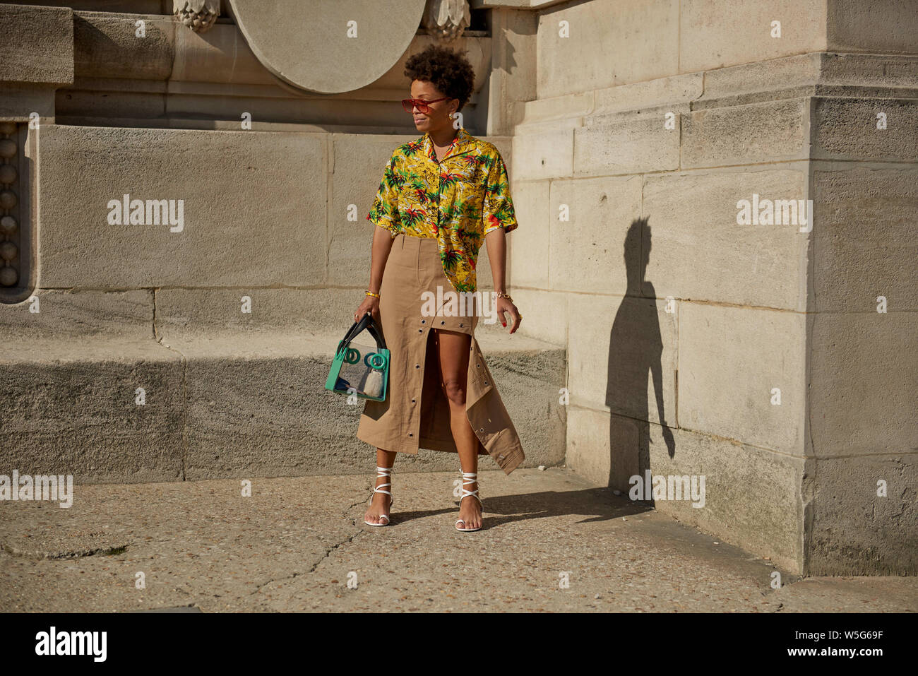 A trendy woman poses for street snaps during the Paris Fashion Week ...