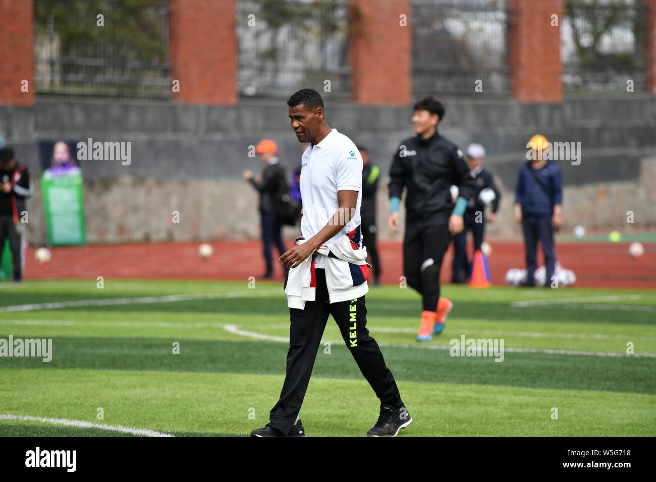 Brazilian football player Aldair plays football with students at an ...