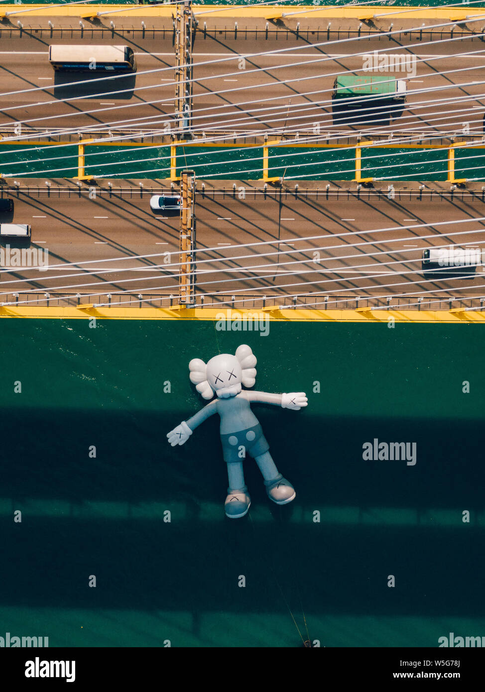 The 37-metre-long floating sculpture by US artist Kaws is placed at the ...