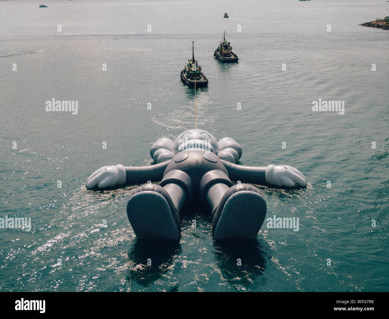 The 37-metre-long floating sculpture by US artist Kaws is placed at the ...