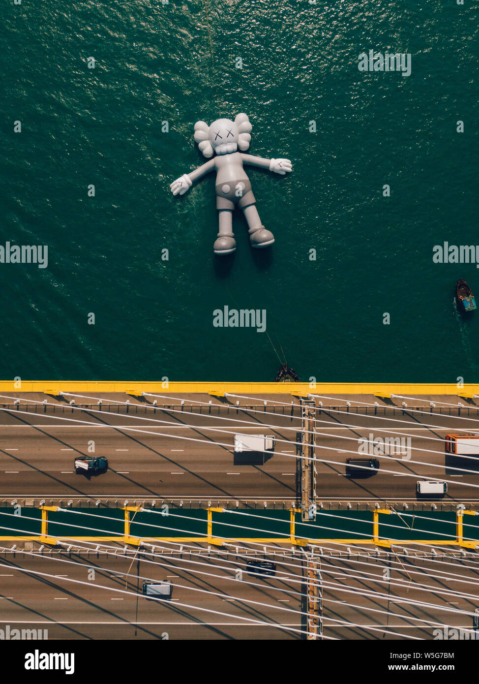 The 37-metre-long floating sculpture by US artist Kaws is placed at the ...