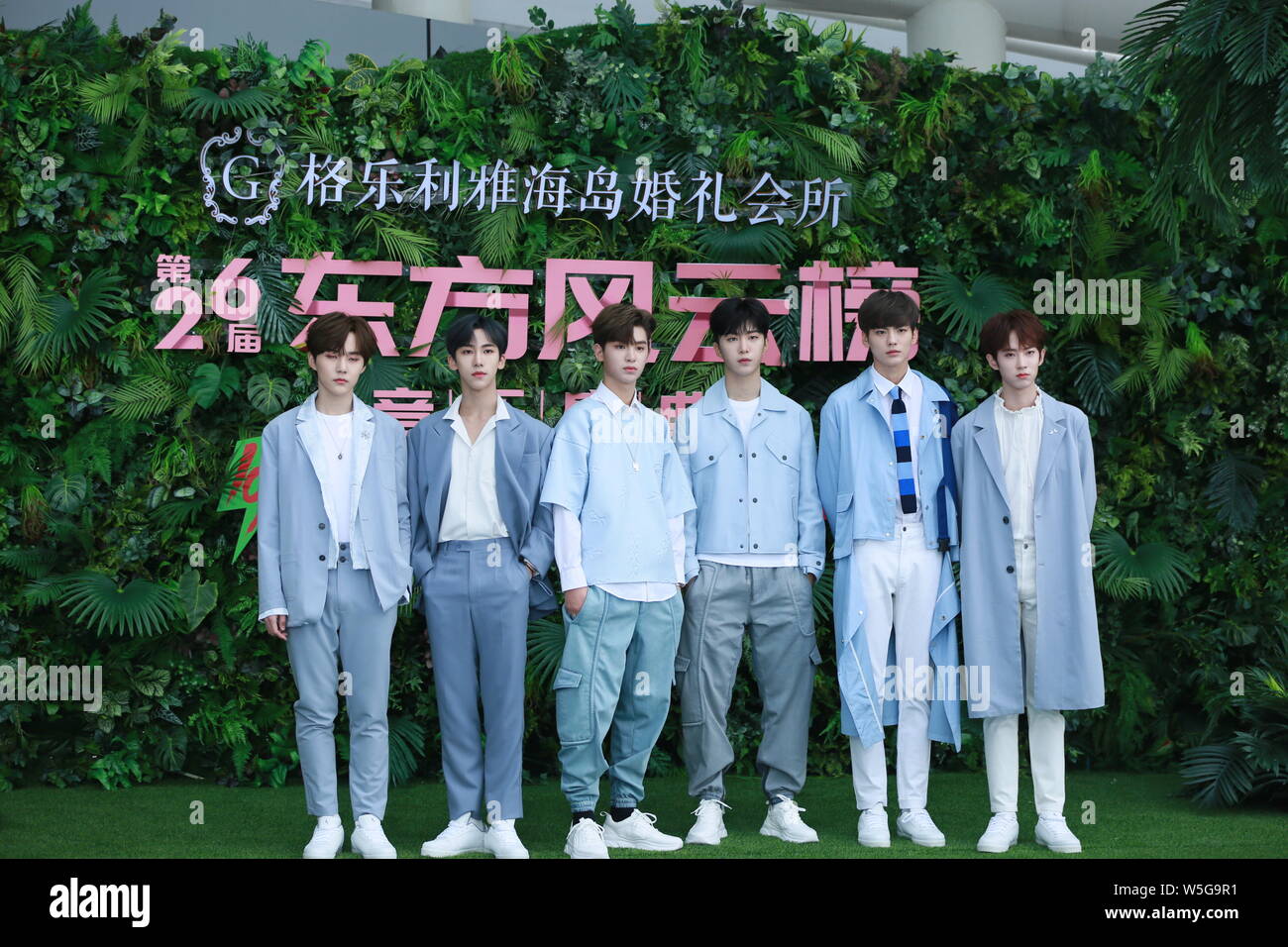 Chinese singer Fan Chengcheng, third right, the younger brother of ...