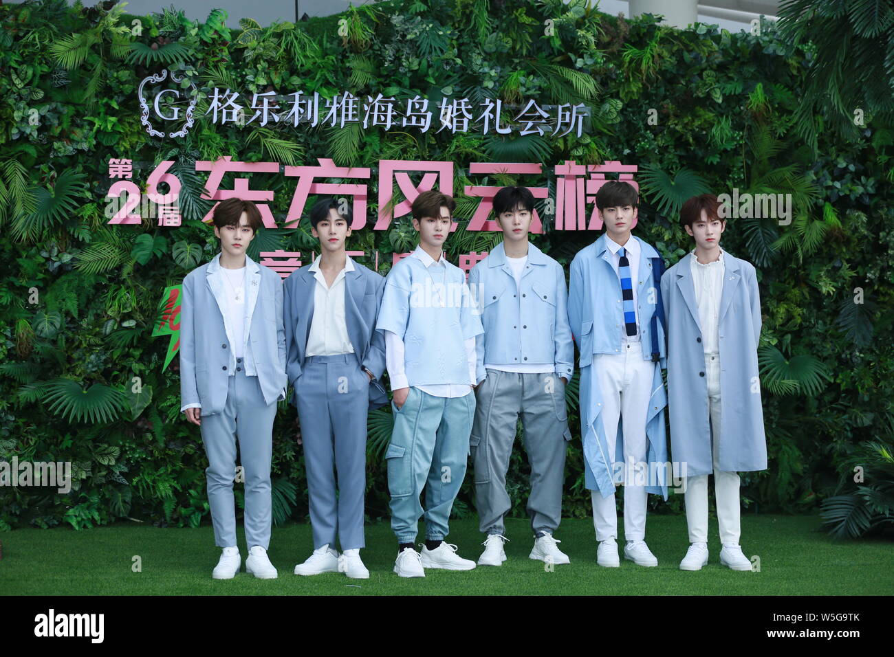 Chinese singer Fan Chengcheng, third right, the younger brother of ...