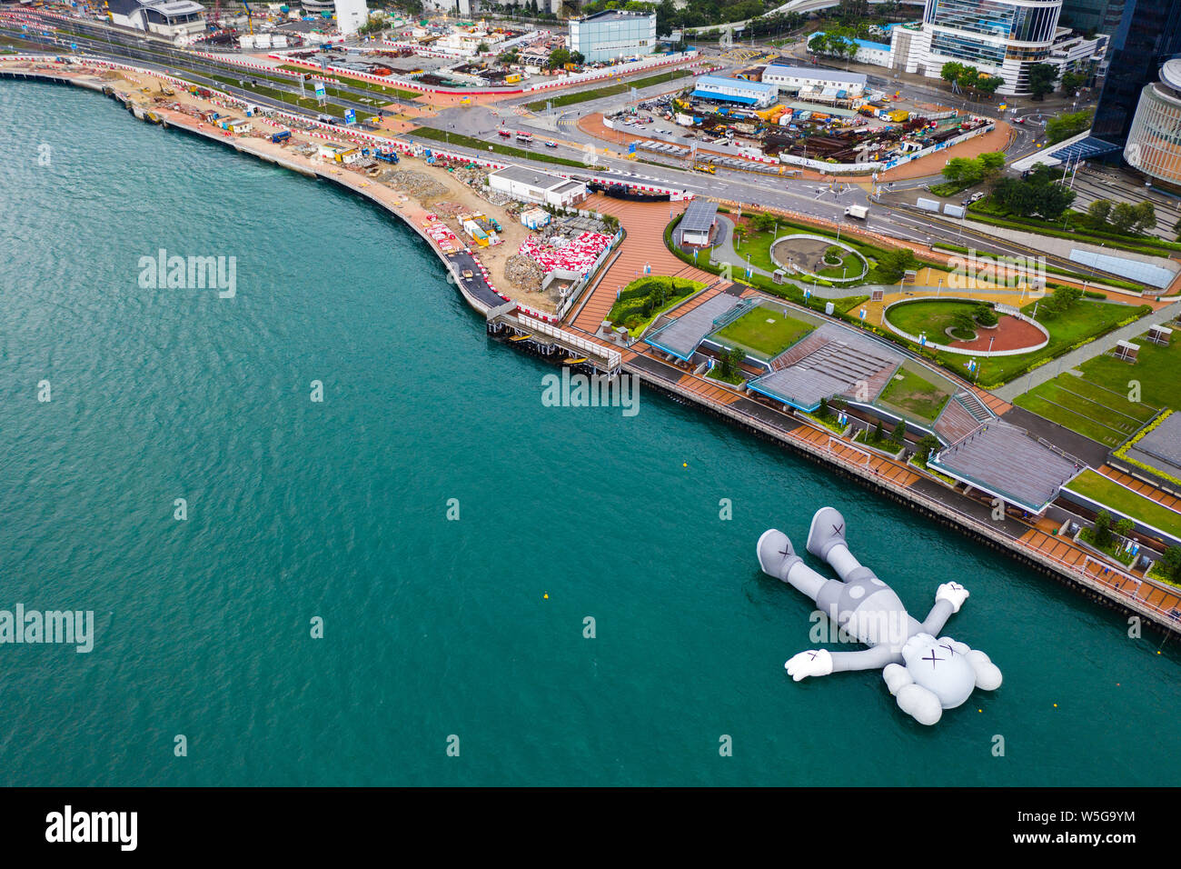The 37-metre-long floating sculpture by US artist Kaws is docked at the ...