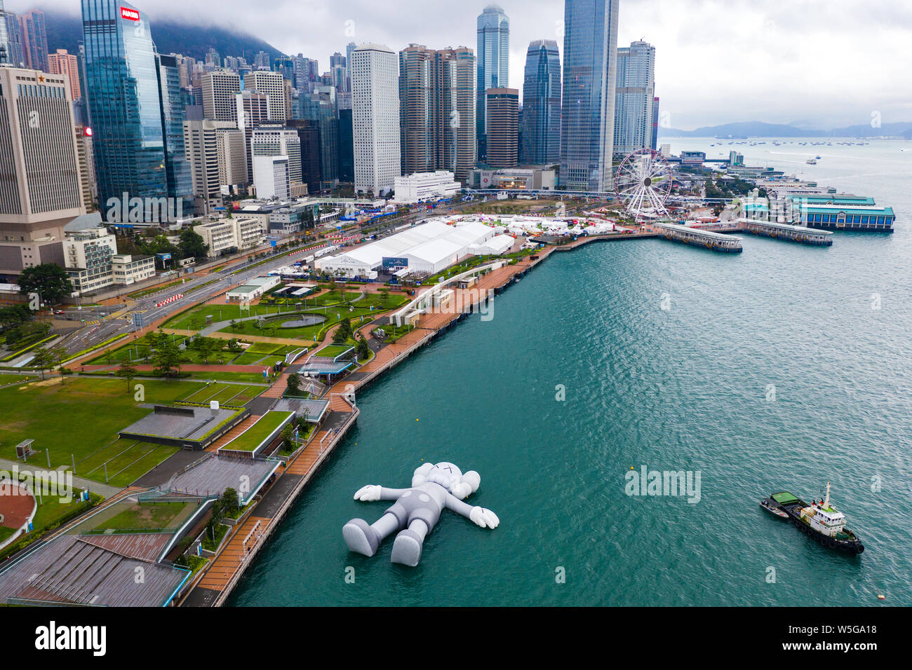 The 37-metre-long floating sculpture by US artist Kaws is docked at the ...