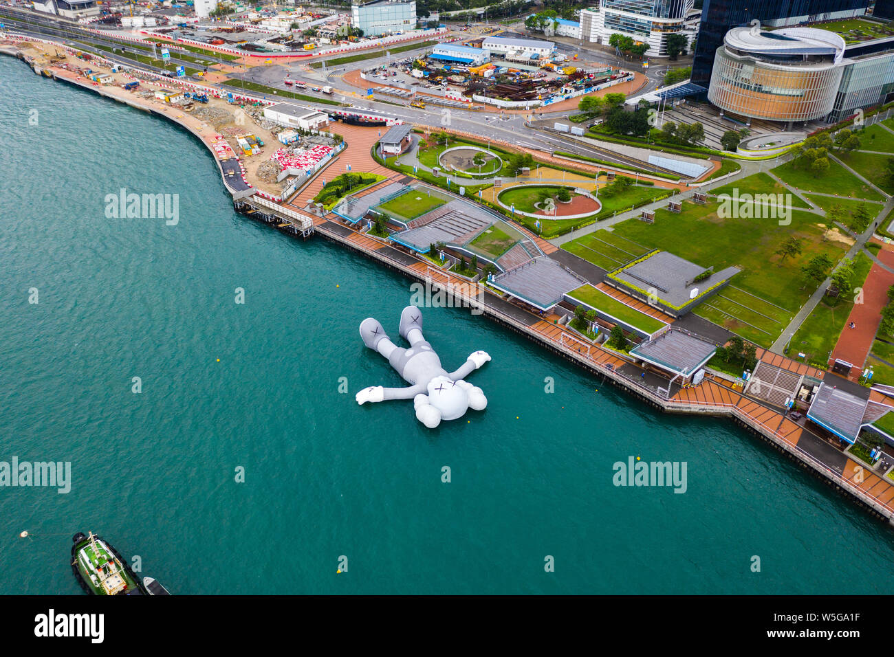 The 37-metre-long floating sculpture by US artist Kaws is docked at the ...