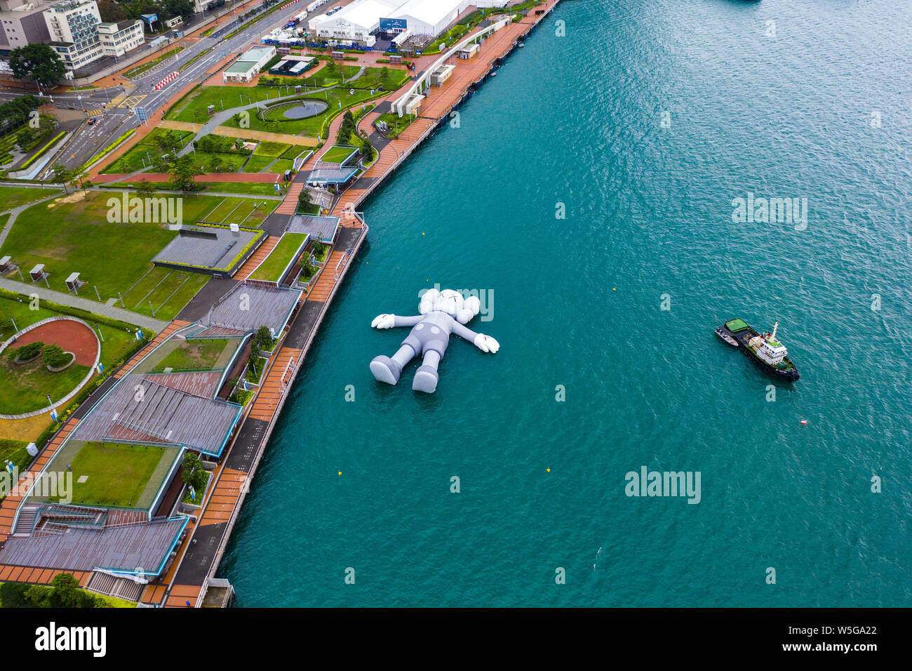 The 37-metre-long floating sculpture by US artist Kaws is docked at the ...