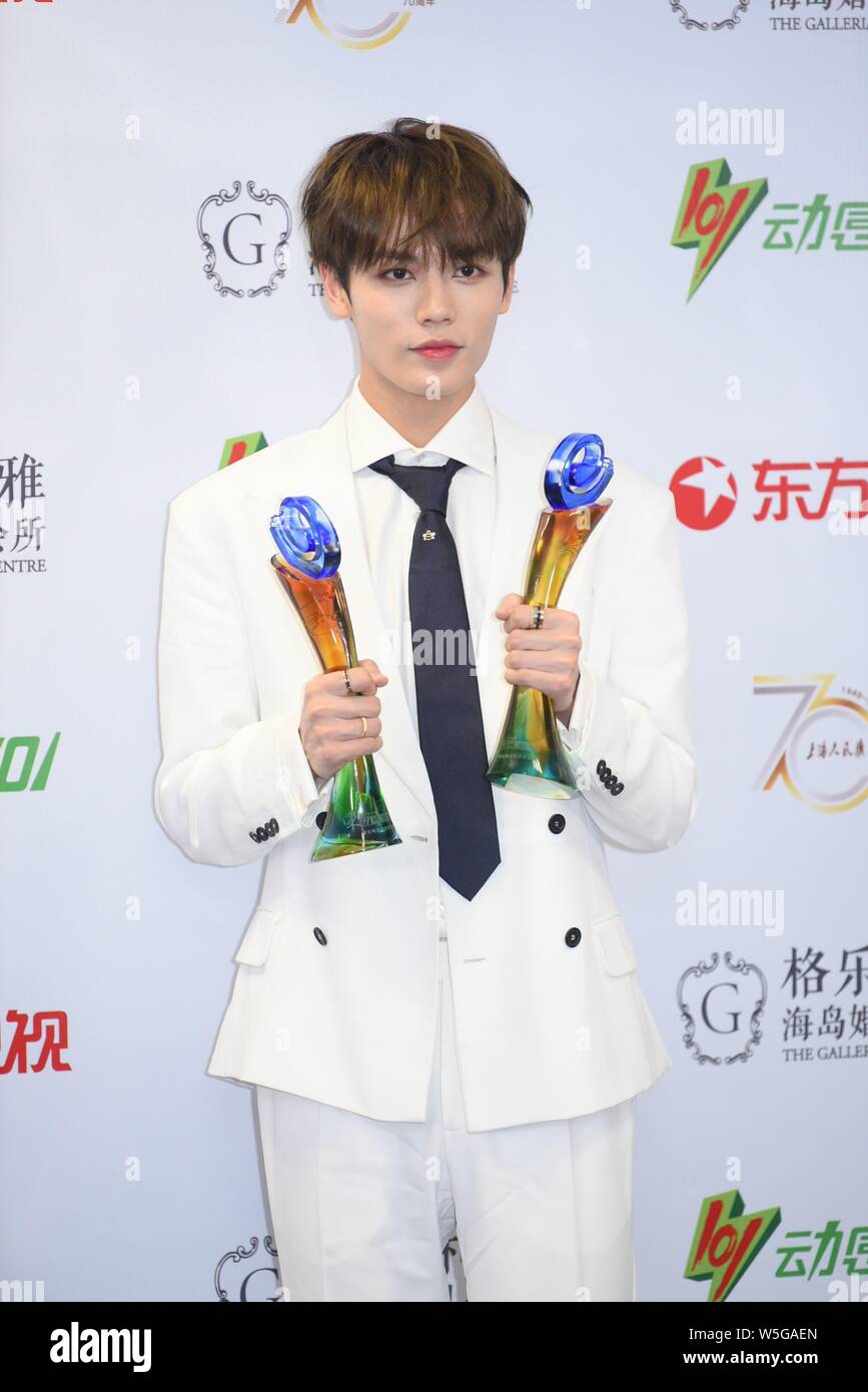 Lin Yanjun of Chinese boy group Nine Percent poses with his trophys ...