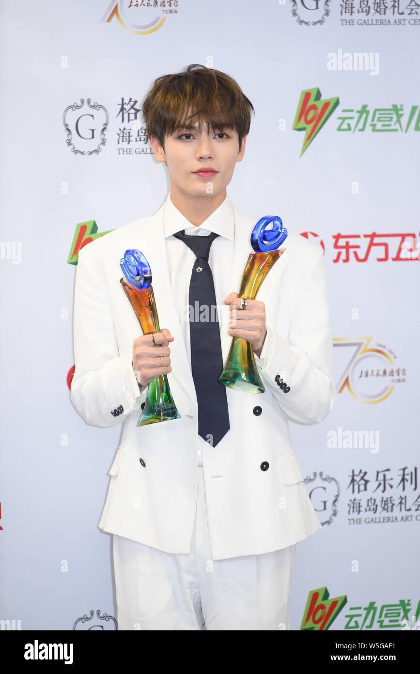 Lin Yanjun of Chinese boy group Nine Percent poses with his trophys ...