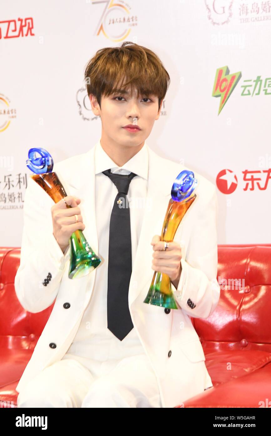 Lin Yanjun of Chinese boy group Nine Percent poses with his trophys ...