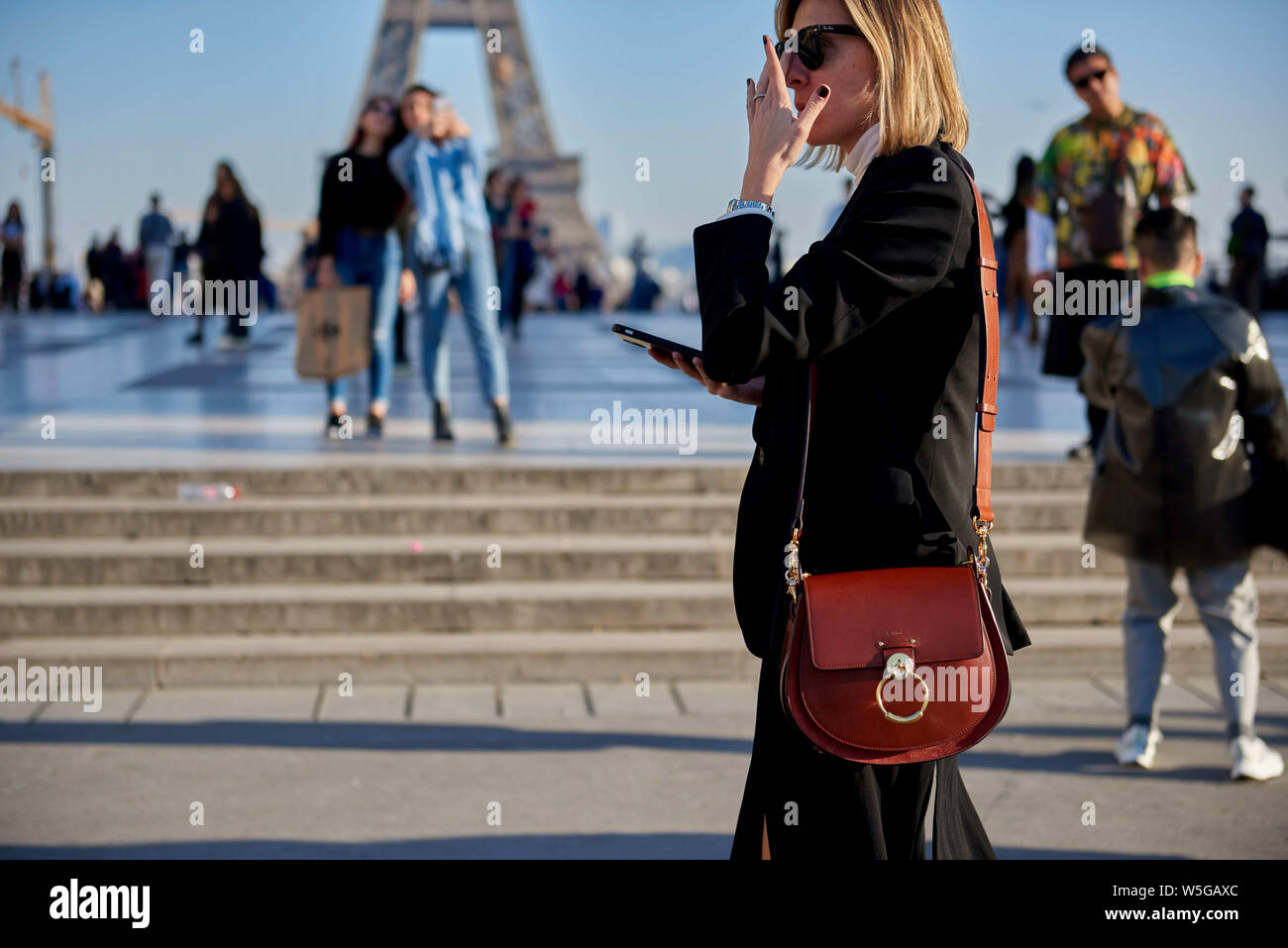 A trendy woman poses for street snaps during the Paris Fashion Week ...