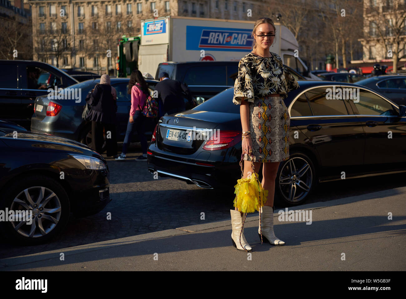 A trendy woman poses for street snaps during the Paris Fashion Week ...