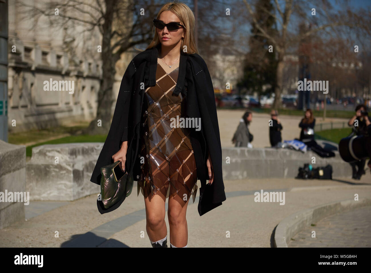 A trendy woman poses for street snaps during the Paris Fashion Week ...