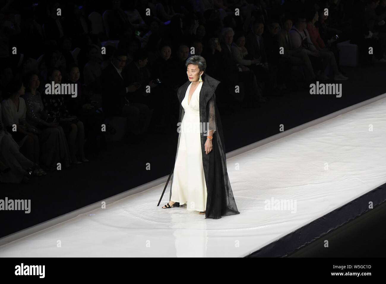 The fashion designer poses at the fashion show of Grace Chen during the ...