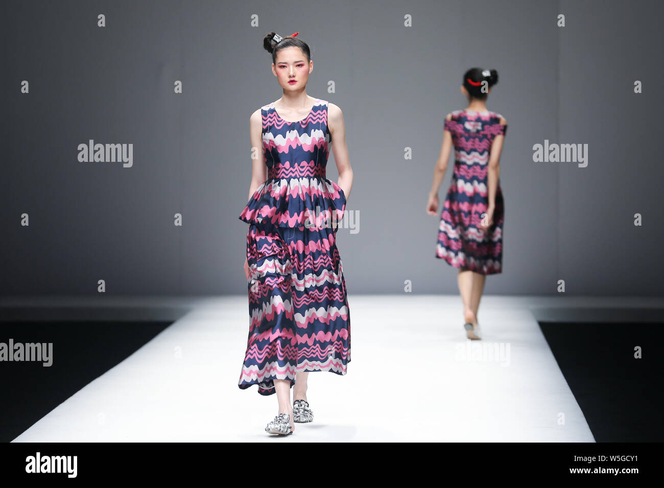 A model displays a new creation at the fashion show of Lli Yang by ...