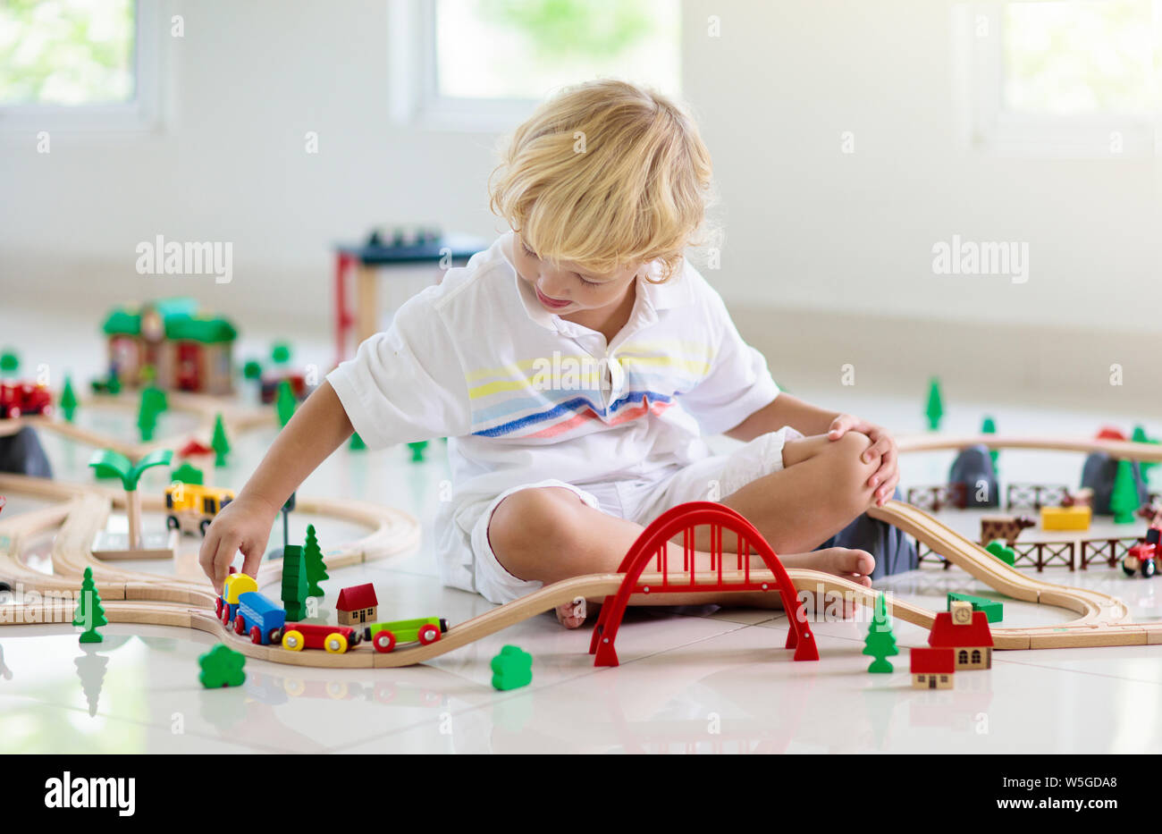 Kids play with wooden railway. Child with toy train. Educational toys ...