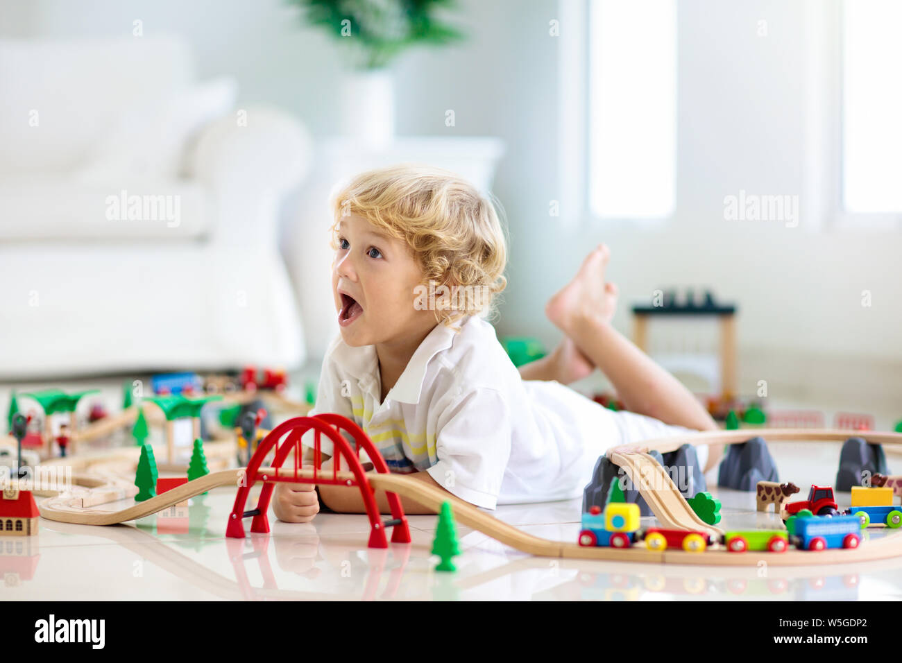 Kids play with wooden railway. Child with toy train. Educational toys ...