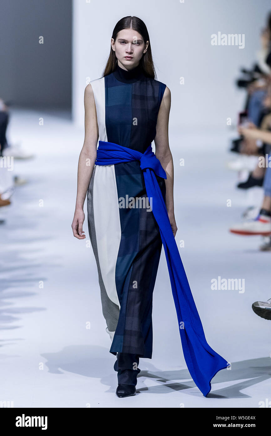 A model displays a new creation at the fashion show of RODERIC WONG during the Shanghai Fashion ...