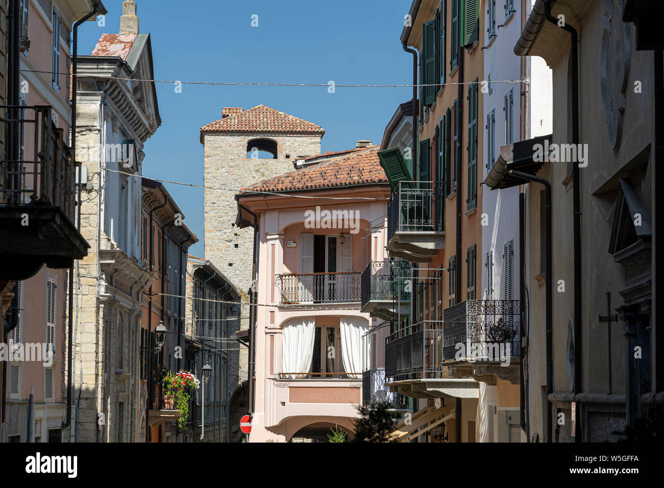Varzi, Pavia, Lombardy, Italy: old typical street with tower and arch ...