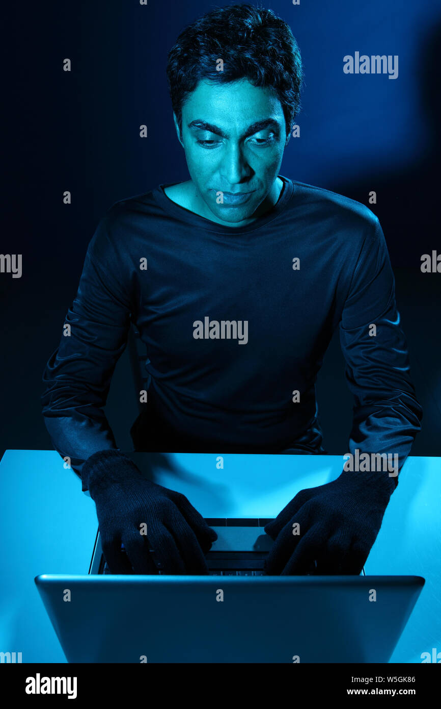 Hacker stealing information from laptop Stock Photo - Alamy