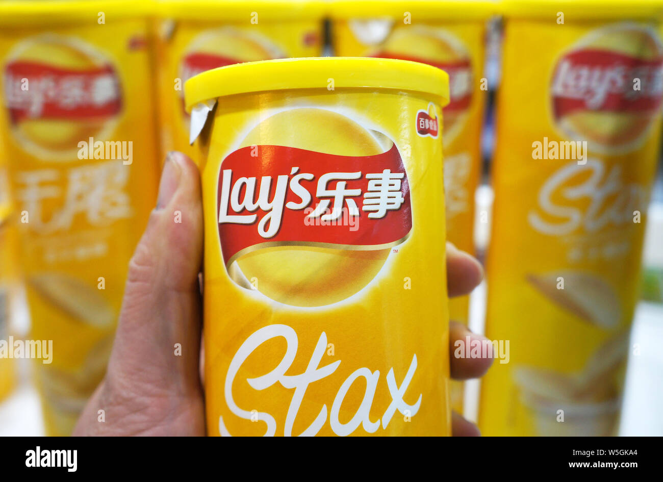 --FILE--A customer shows a snack package of Lays potato chips produced ...