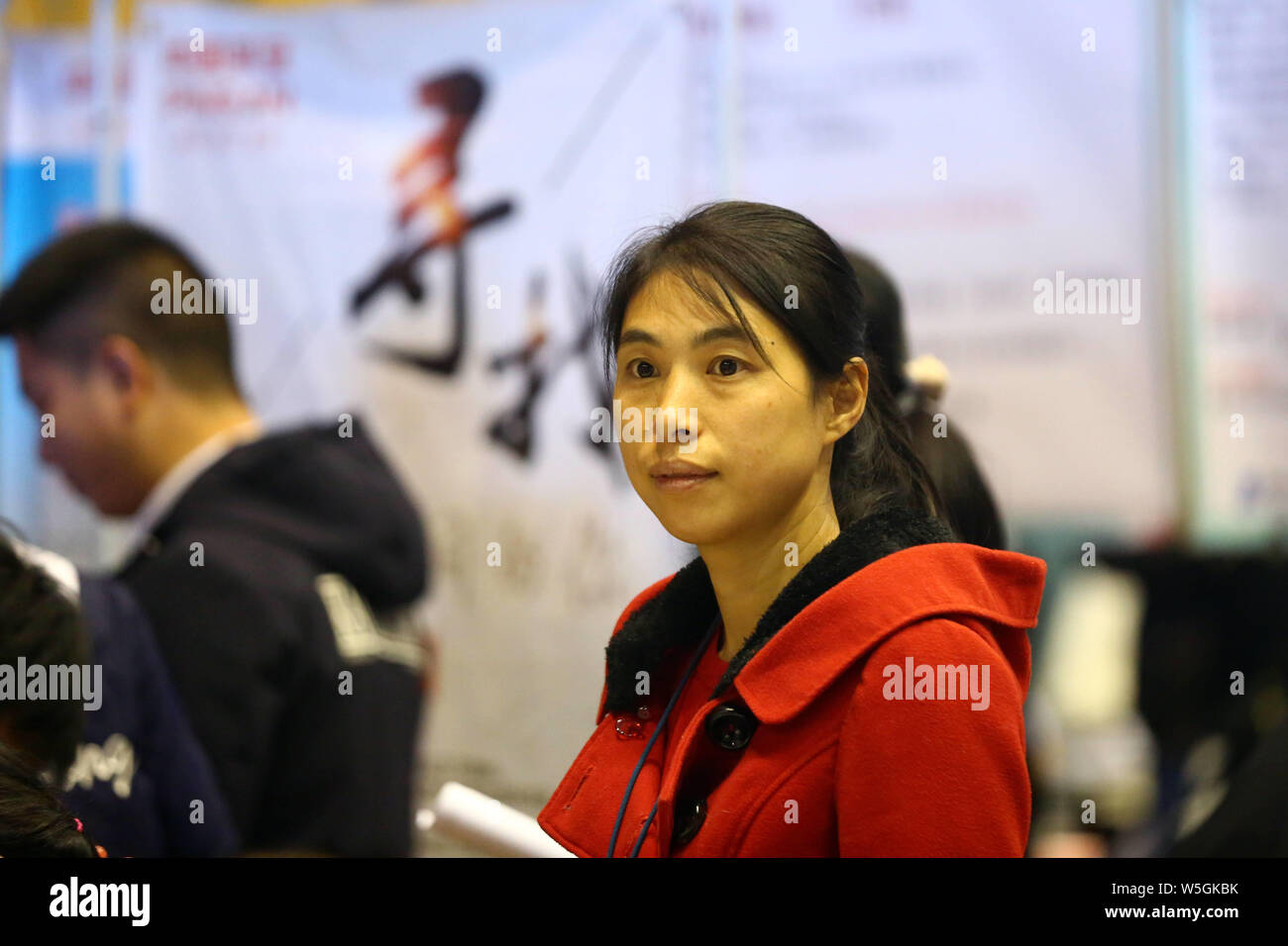 --FILE--A Chinese female job seeker looks for employment at a job fair ...