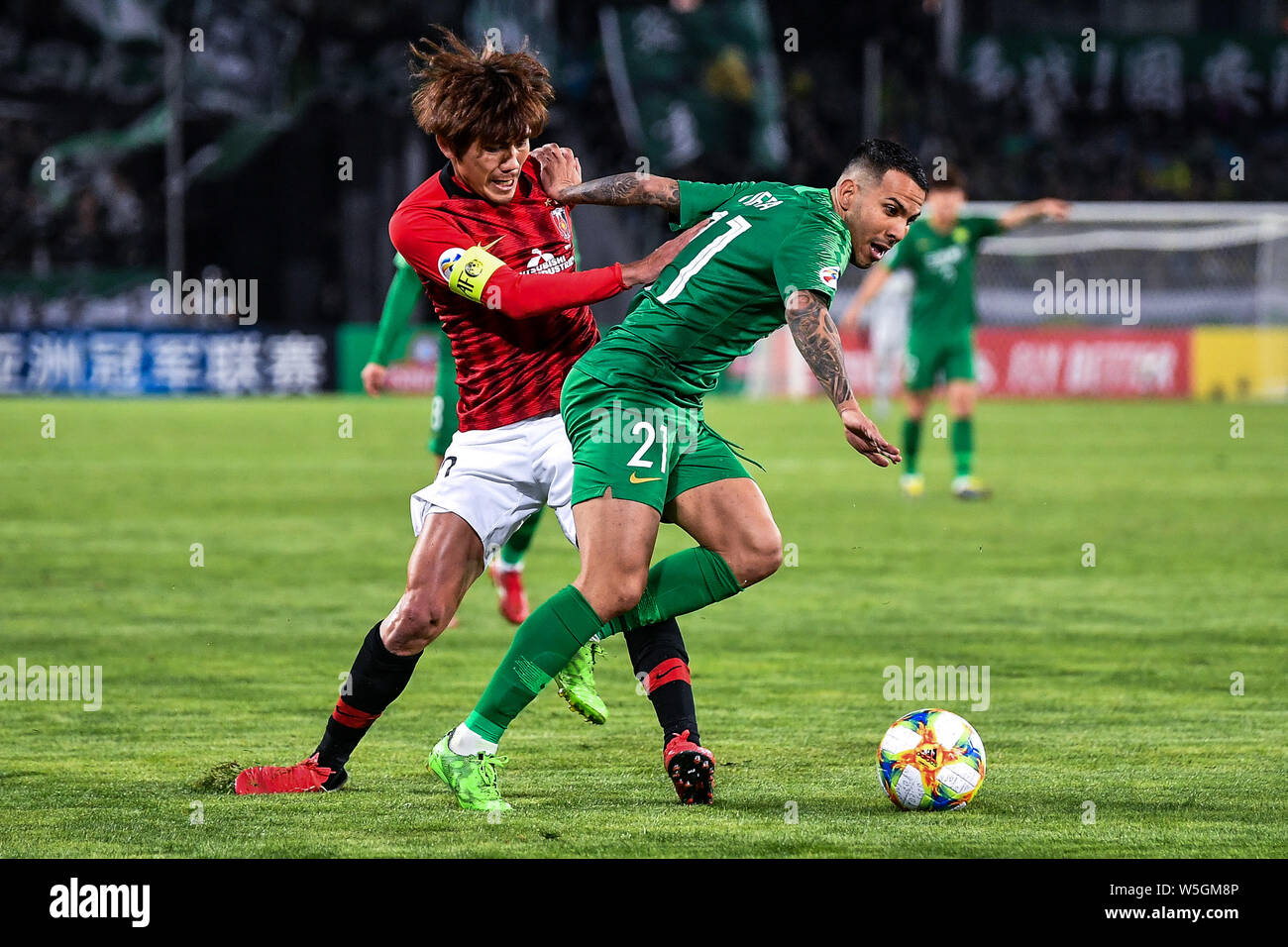 Spanish football player Jonathan Viera, right, of China's Beijing Guoan ...