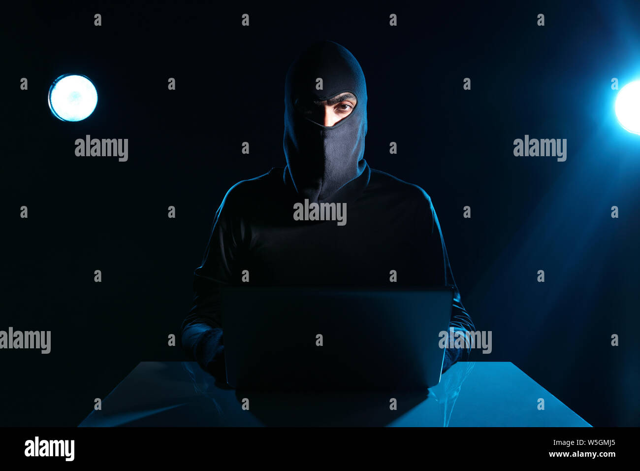 Hacker stealing information from laptop Stock Photo - Alamy