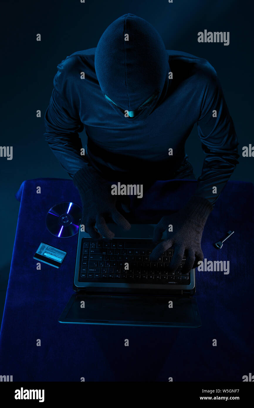 Hacker stealing information from laptop Stock Photo - Alamy