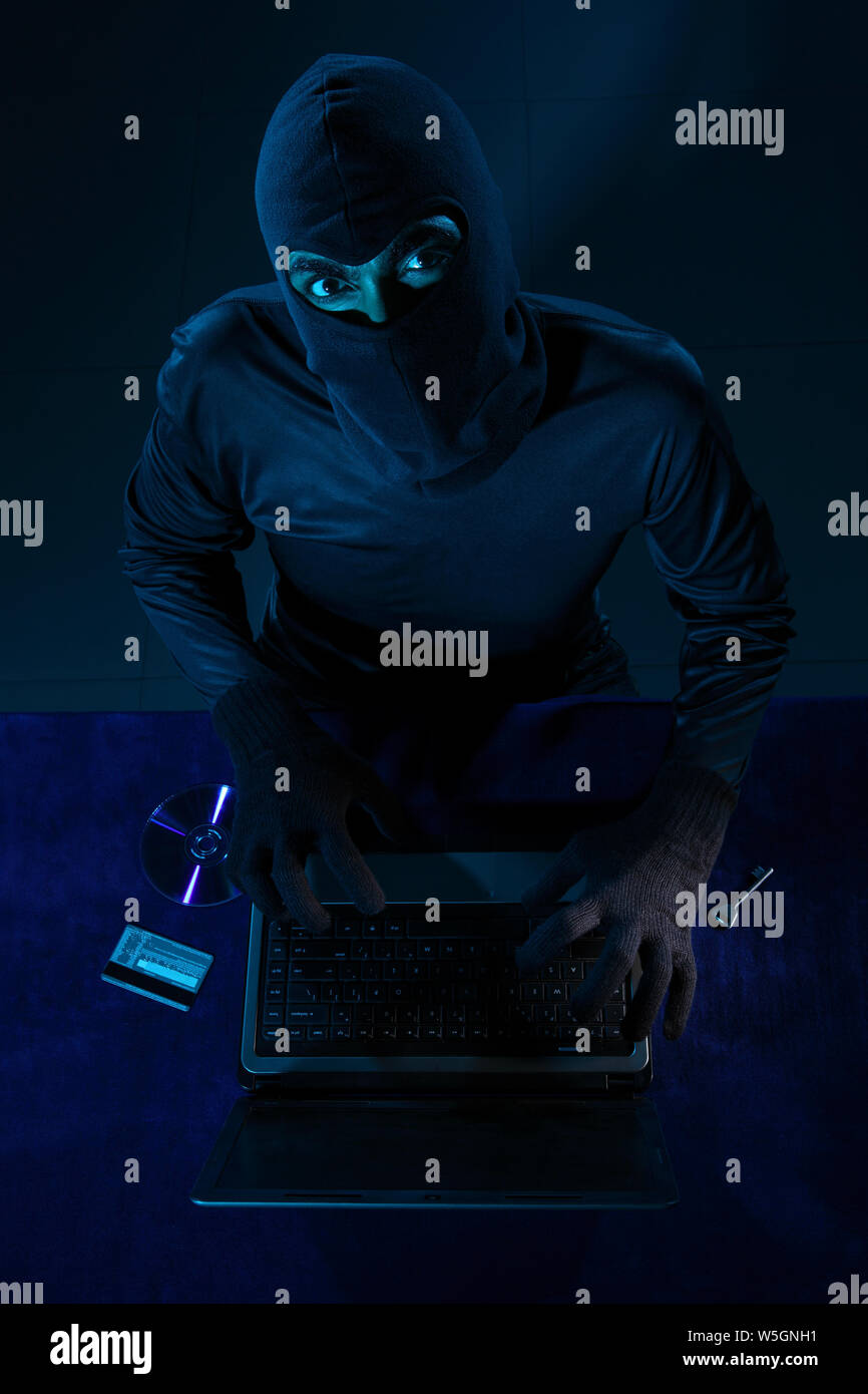 Hacker stealing information from laptop Stock Photo - Alamy