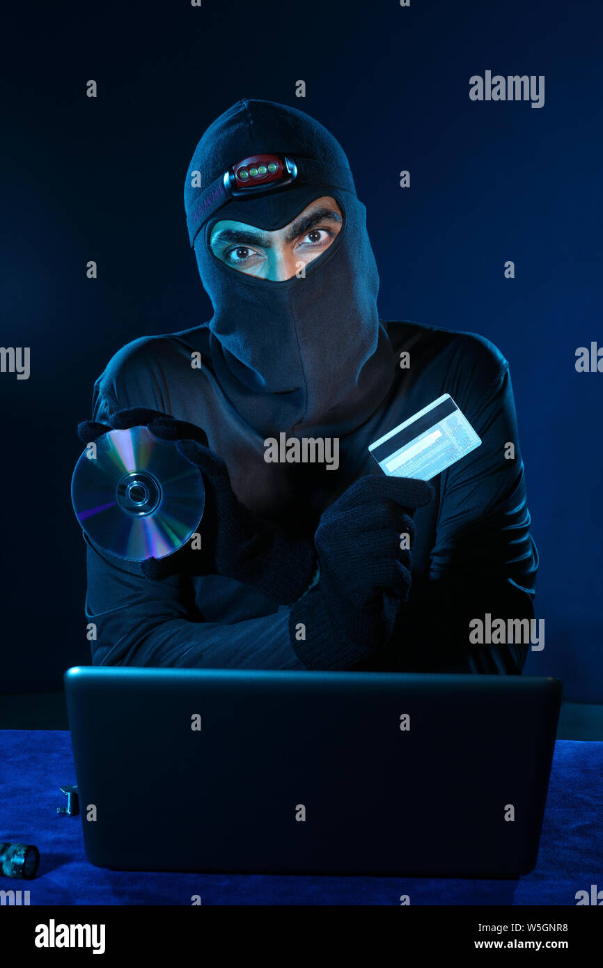 Hacker stealing information from laptop Stock Photo - Alamy