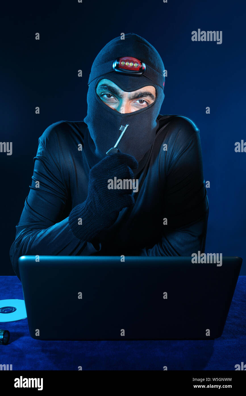 Hacker stealing information from laptop Stock Photo - Alamy