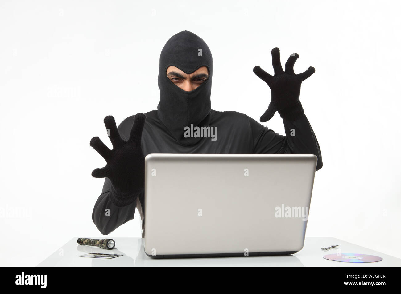 Hacker stealing information from laptop Stock Photo - Alamy