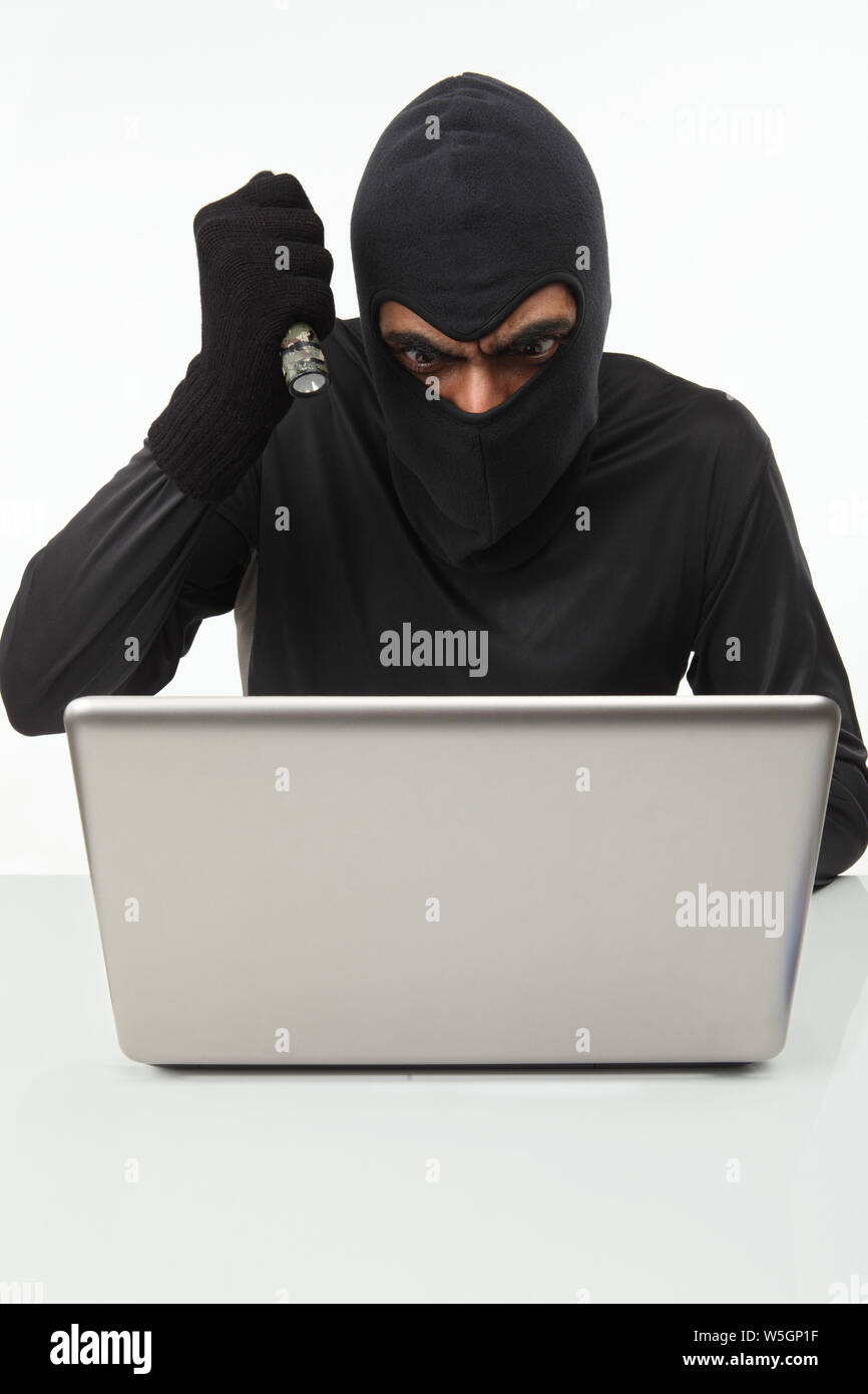 Hacker stealing information from laptop Stock Photo - Alamy