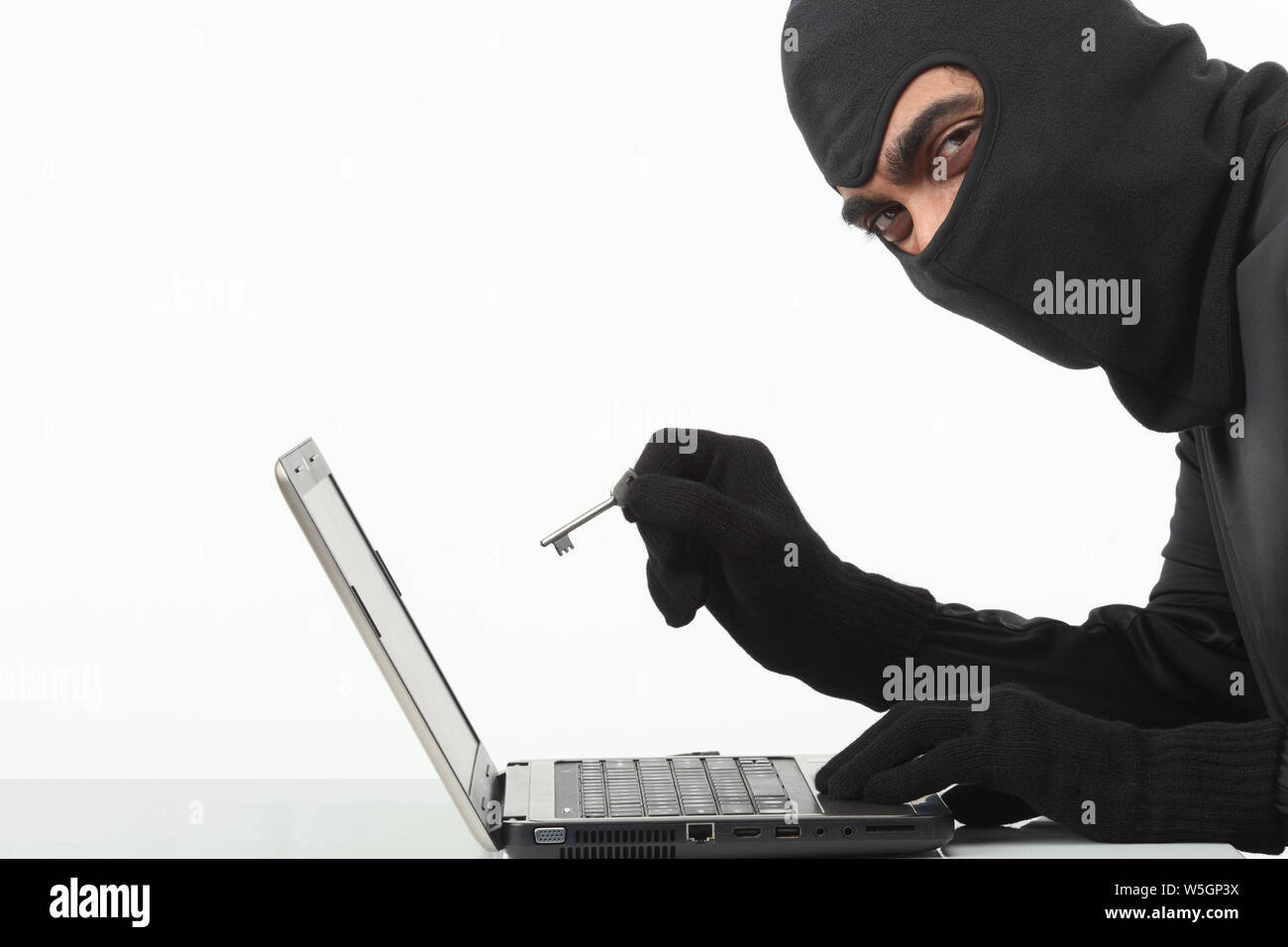 Hacker stealing information from laptop Stock Photo - Alamy